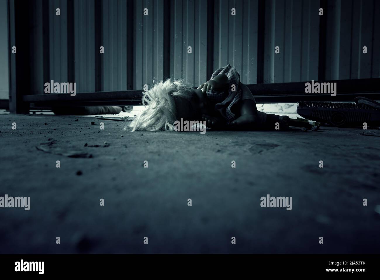 Broken doll among rubble, war childhood destroyed Stock Photo - Alamy
