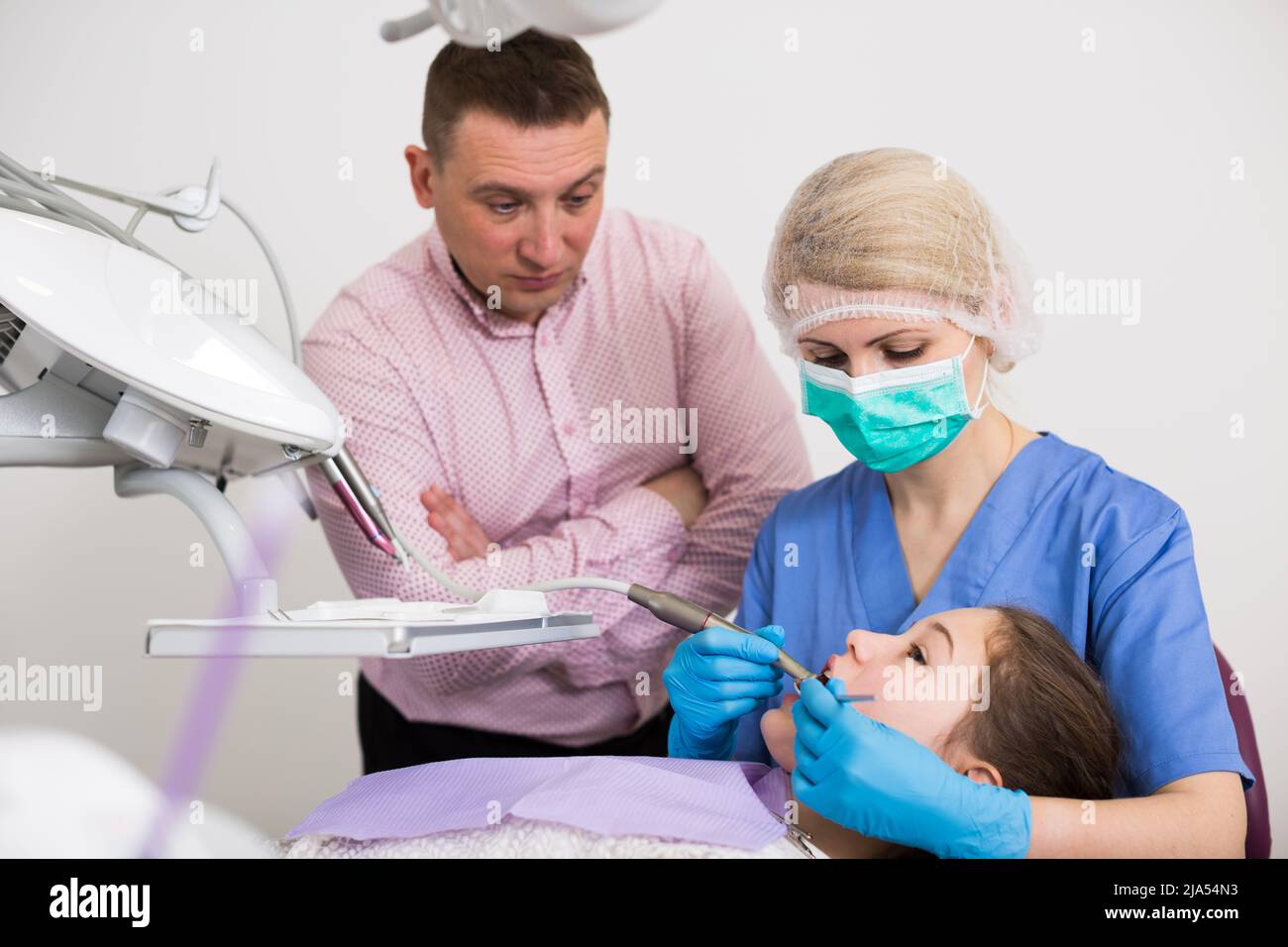 Girl visiting dentistry with father Stock Photo - Alamy