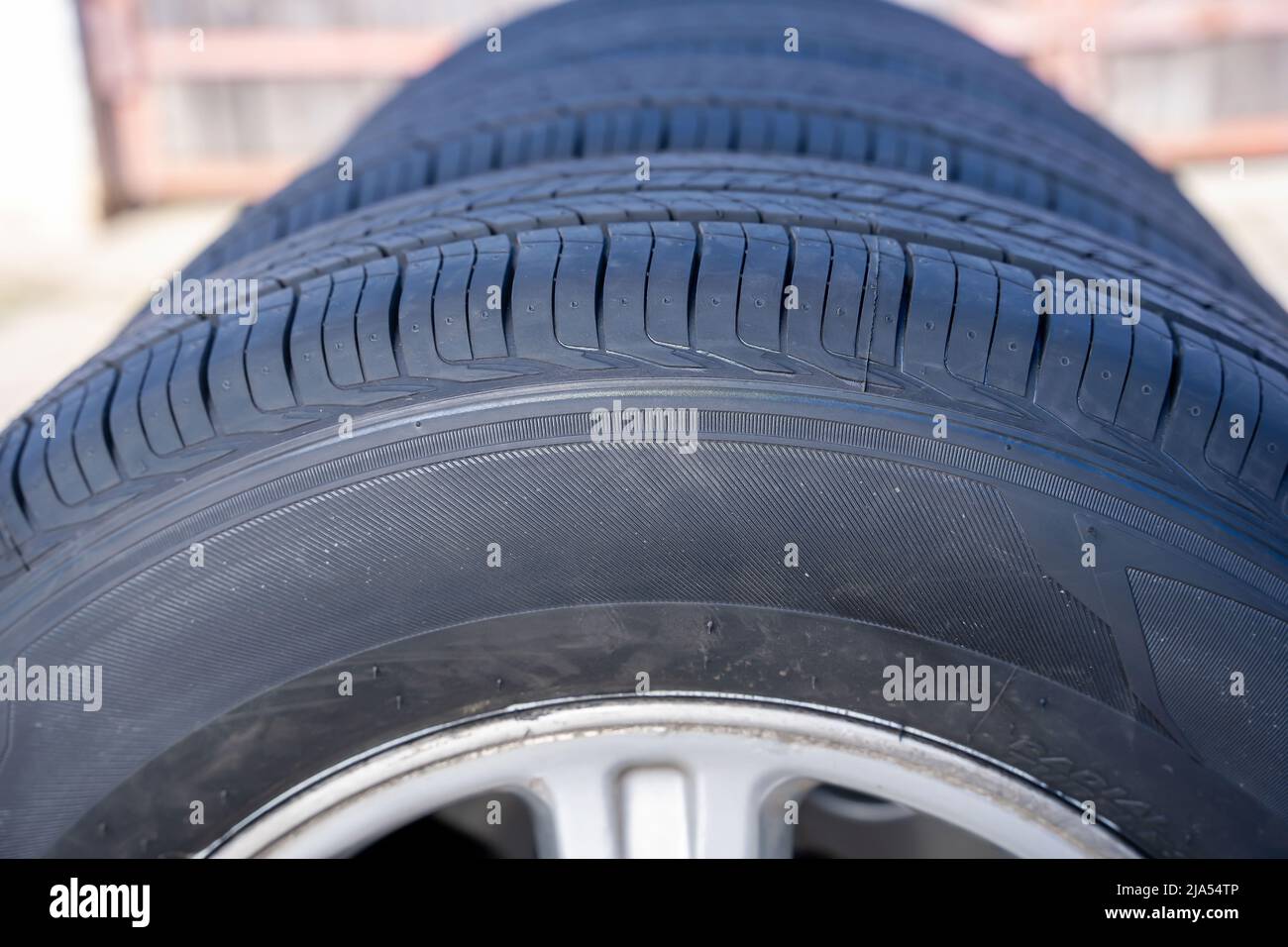 new car summer tires in a row. Car tire tread close-up Stock Photo - Alamy