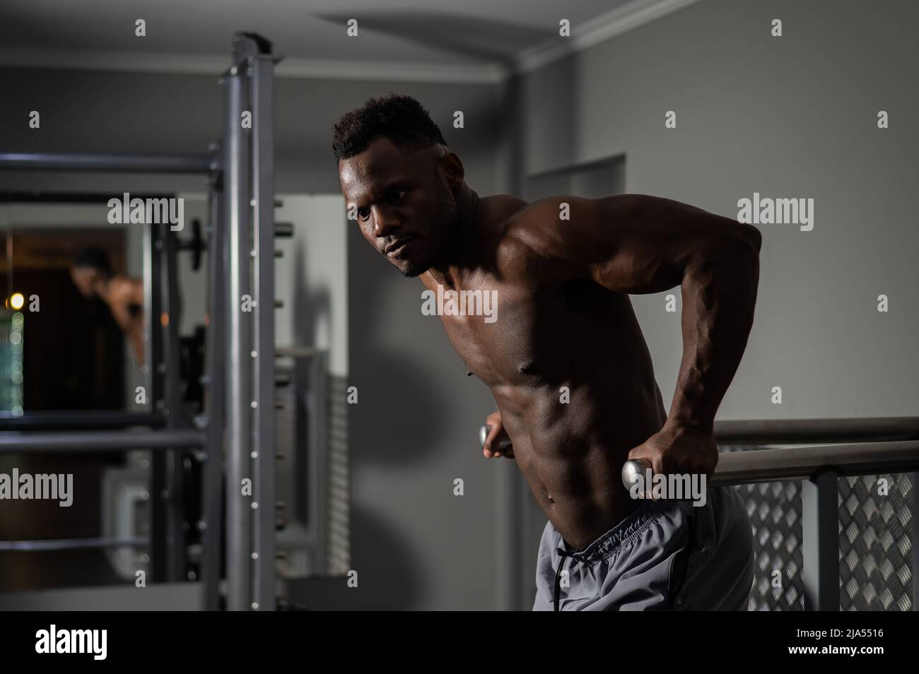 Handsome afro american man doing parallel bars exercise in gym Stock ...