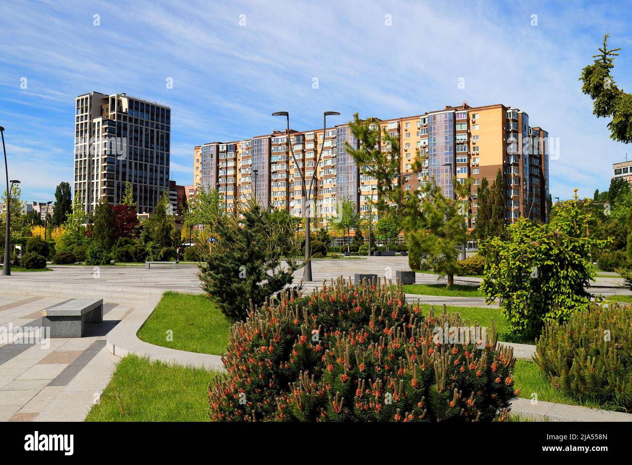 A beautiful park against tall houses, buildings and skyscrapers, urban ...