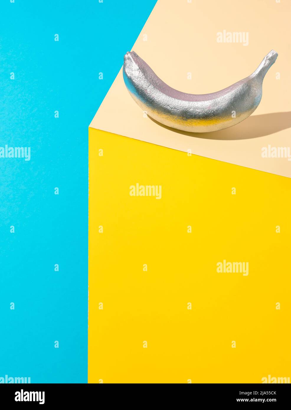 Modern optical illusion made of silver banana on colorful background ...