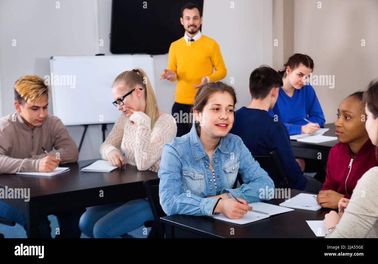 Fellow students having group work tasks during school day Stock Photo ...