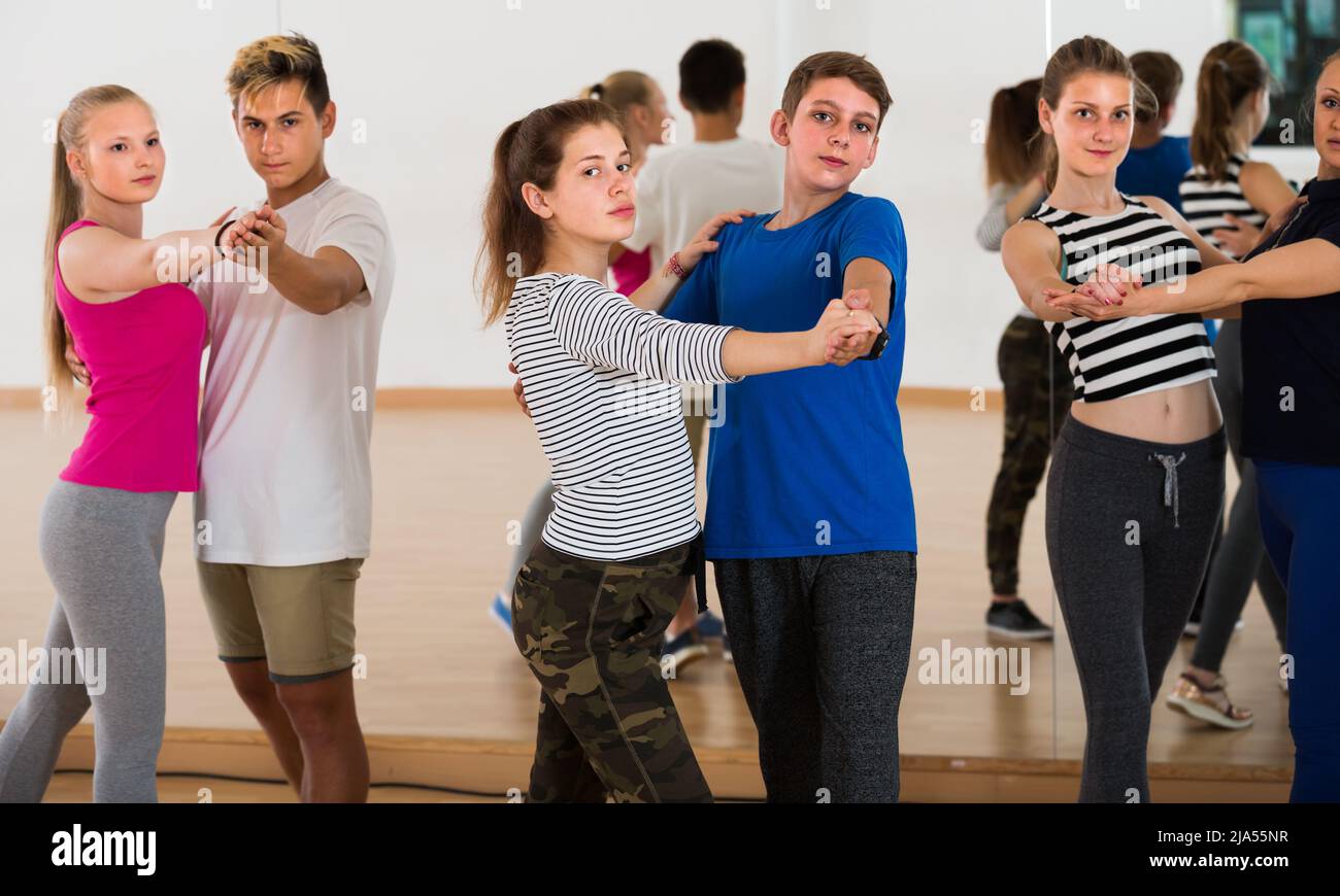 Group of happy teen dancing tango in dance studio Stock Photo - Alamy