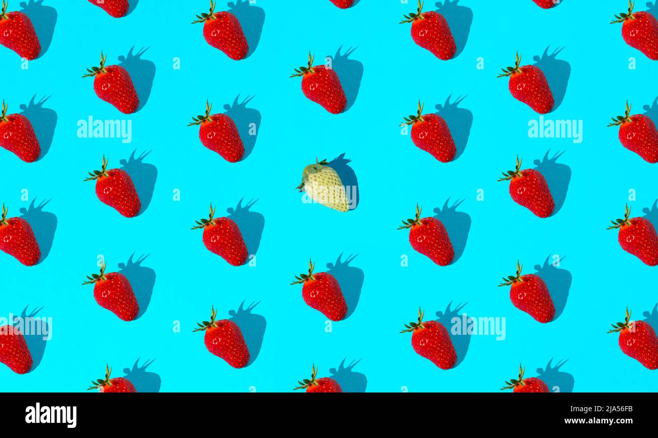 Pattern made of ripe strawberries against pastel blue background with ...