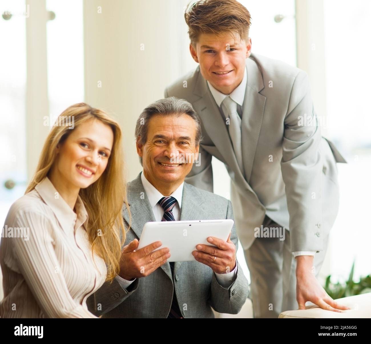 serious business team with tablet pc computers, documents having ...