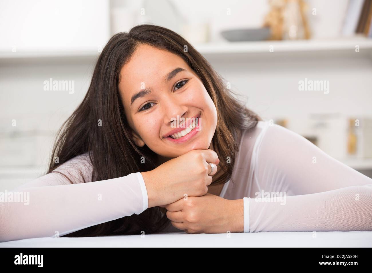 Positive teenager girl smiling at home Stock Photo - Alamy
