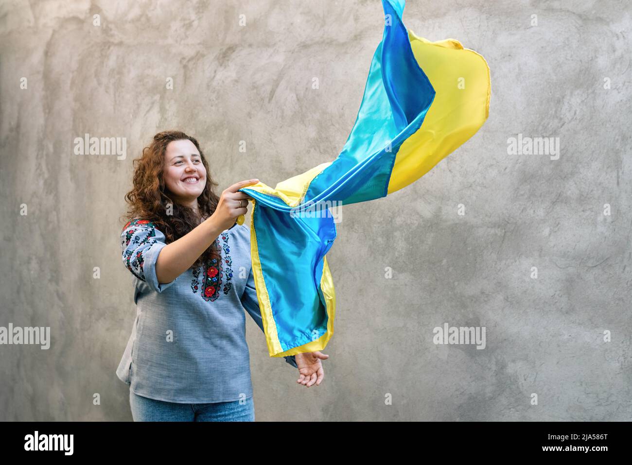 Soft selective focus on a smiling girl holding blue and yellow national ...