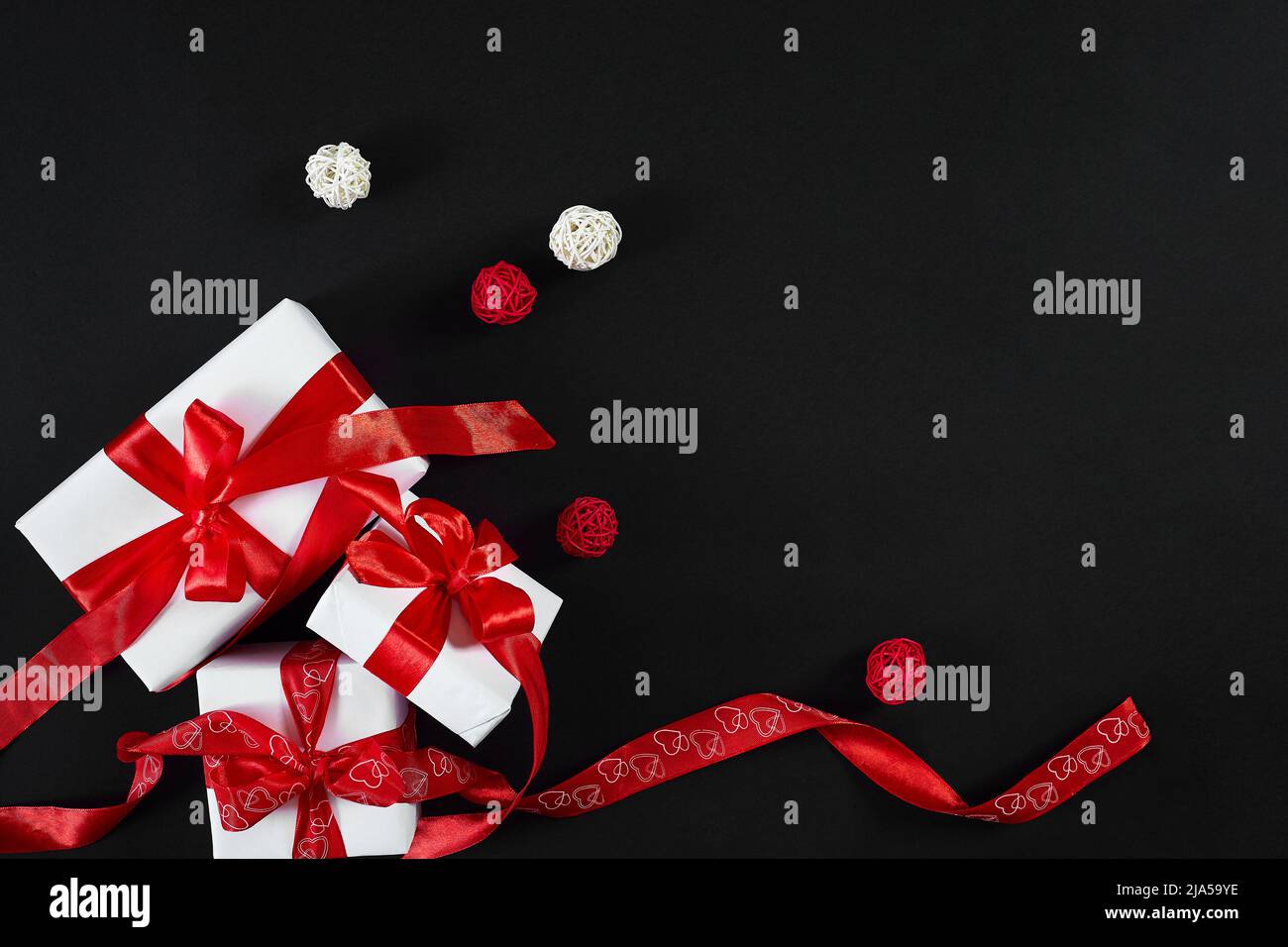 White gift boxes with red ribbon on black background. Valentines Stock ...