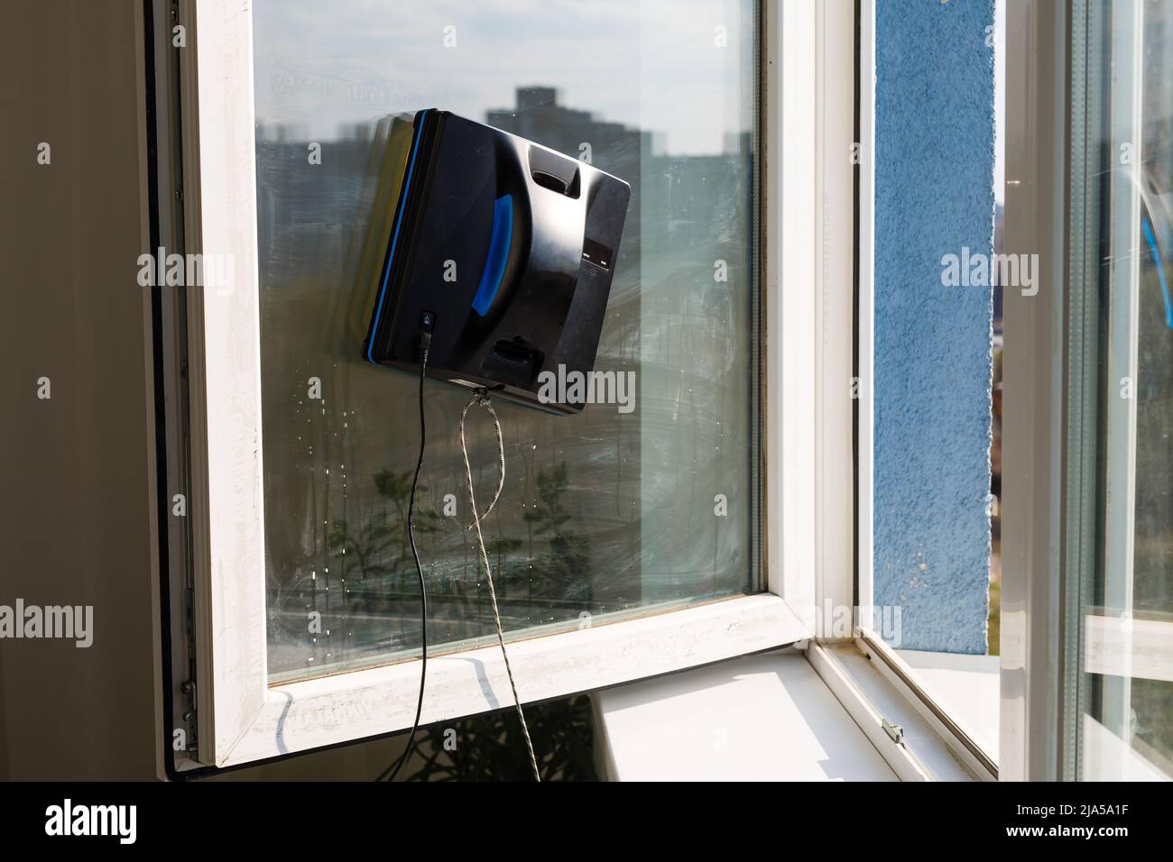 Detail of a glass cleaning robots acting behind a window Stock Photo ...