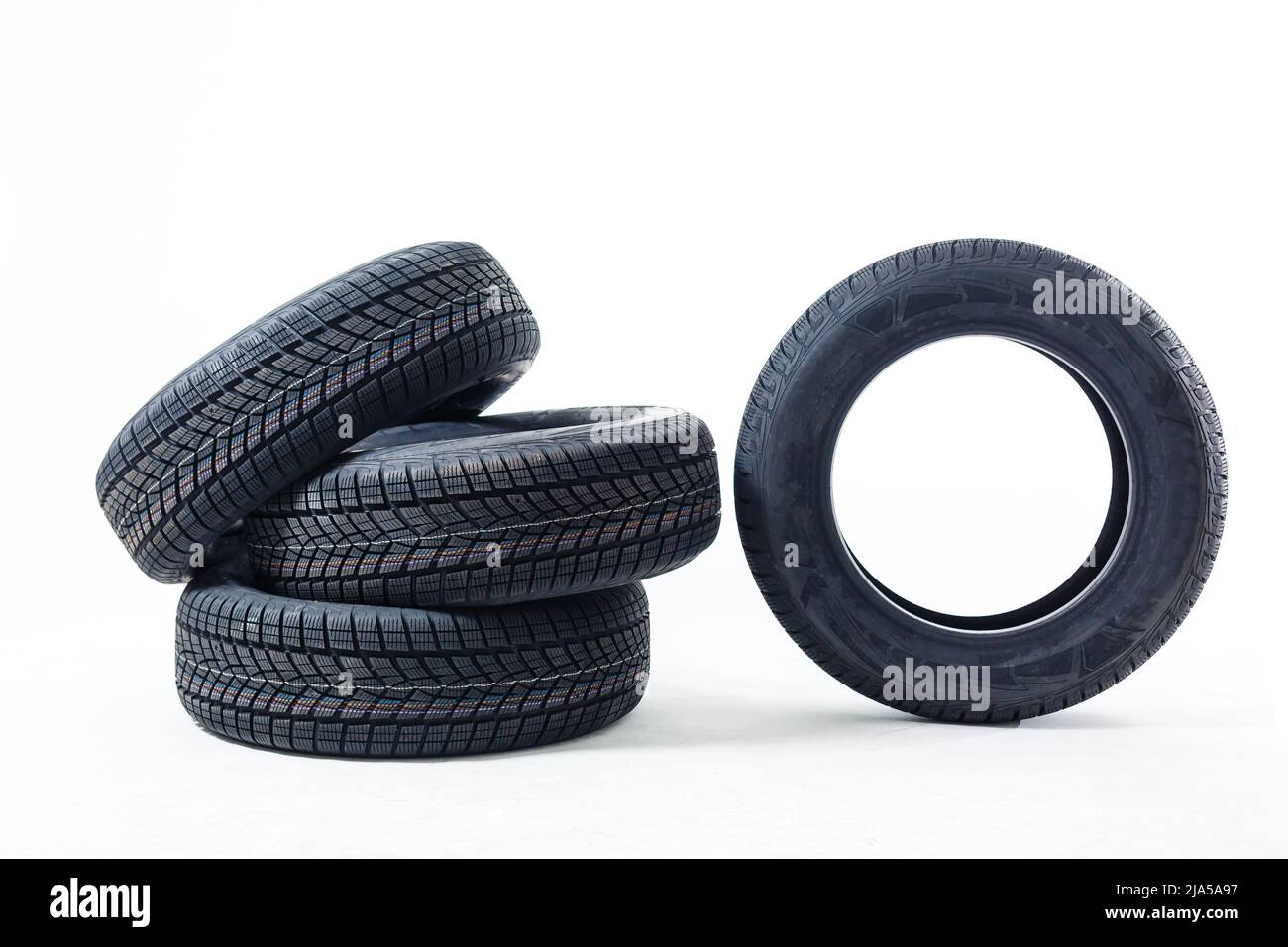 four black tires isolated on white background Stock Photo - Alamy