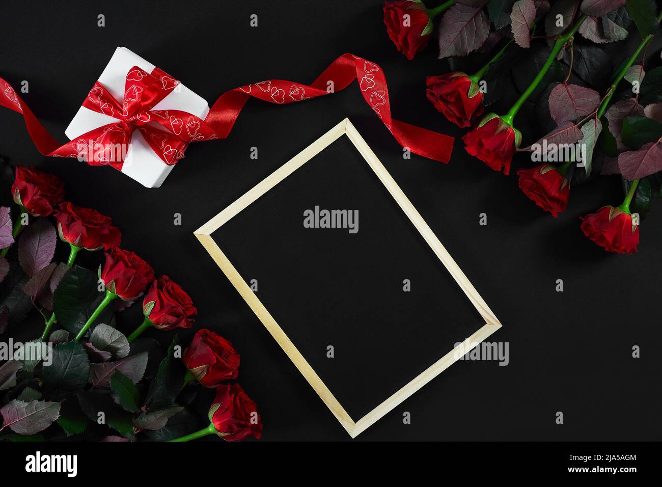 Red roses and empty chalk board on black background. Valentines Stock ...
