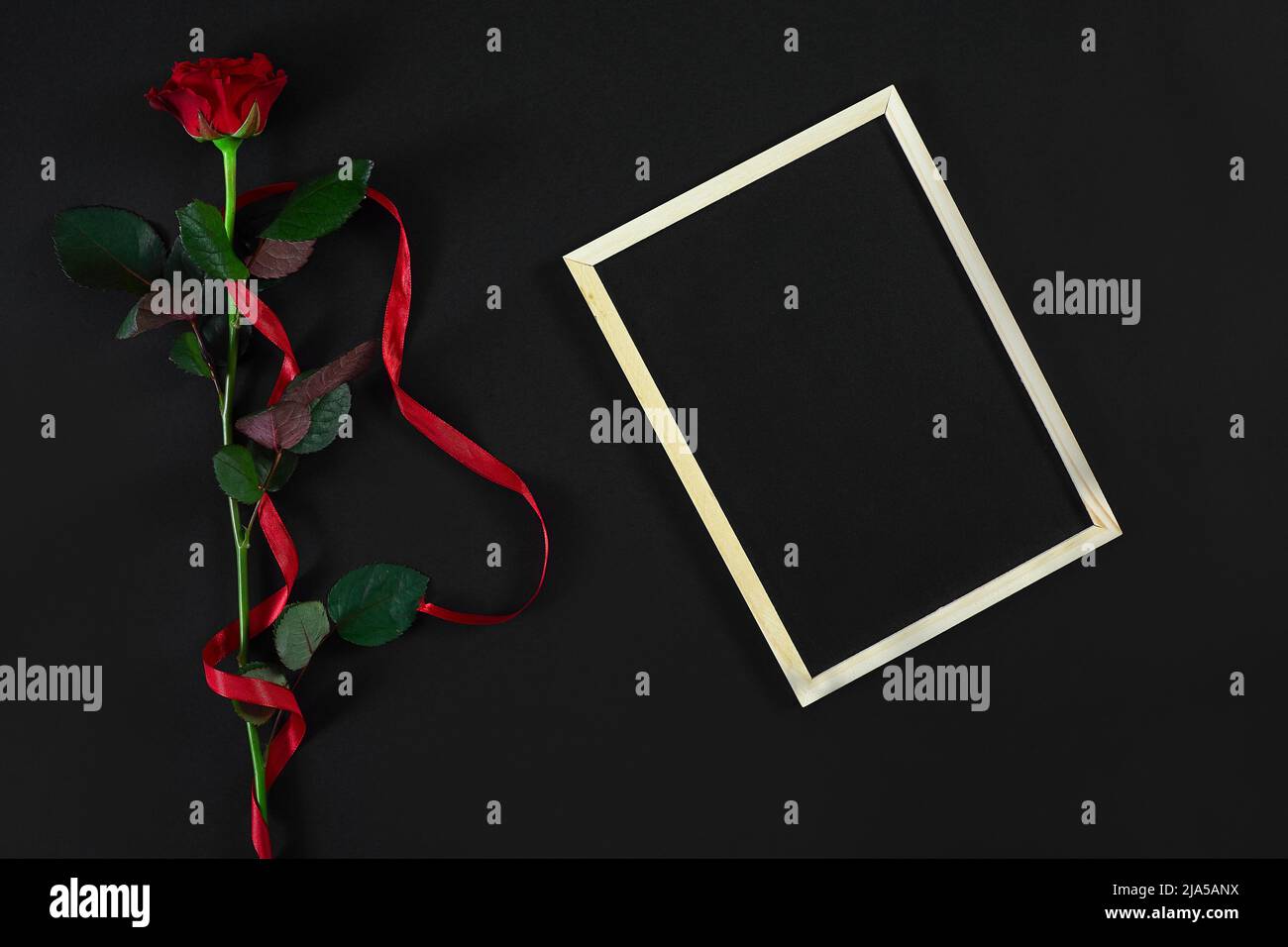 Red rose and empty chalk board on black background. Valentines d Stock ...