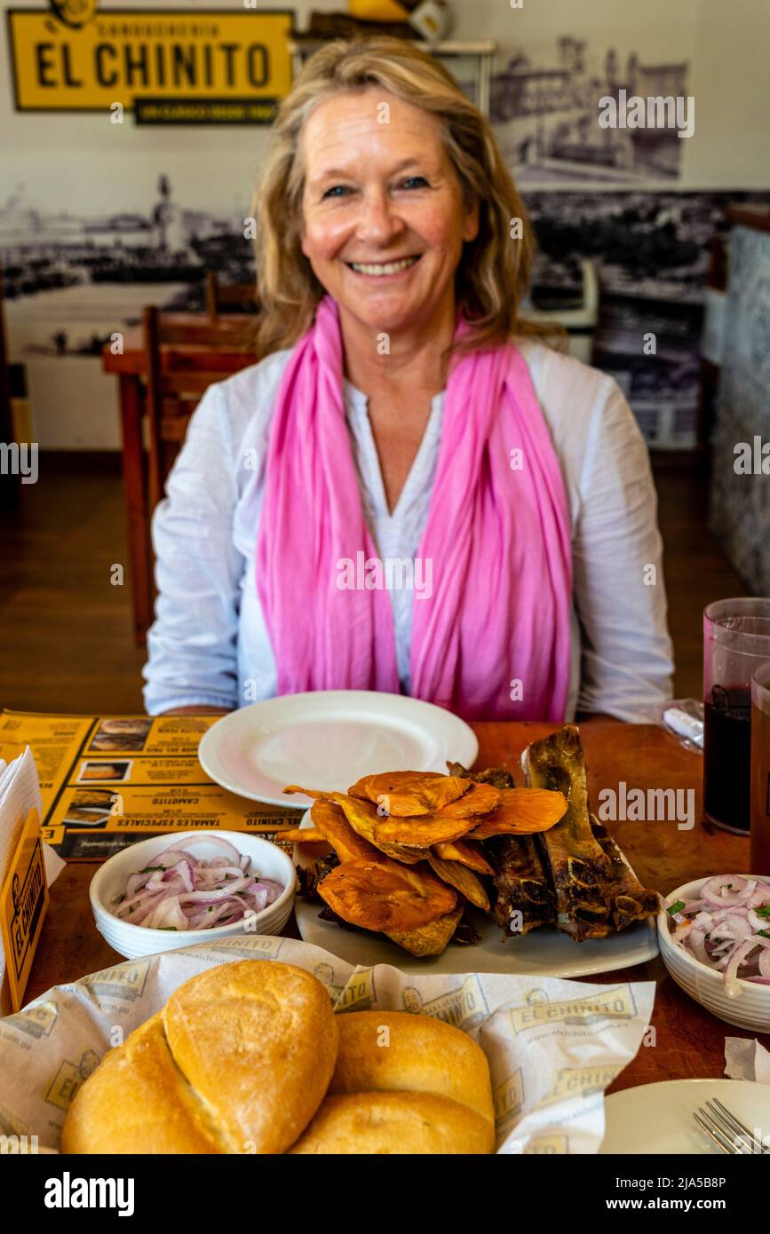 A Female Tourist Eating Traditional Peruvian Food At A Restaurant In ...