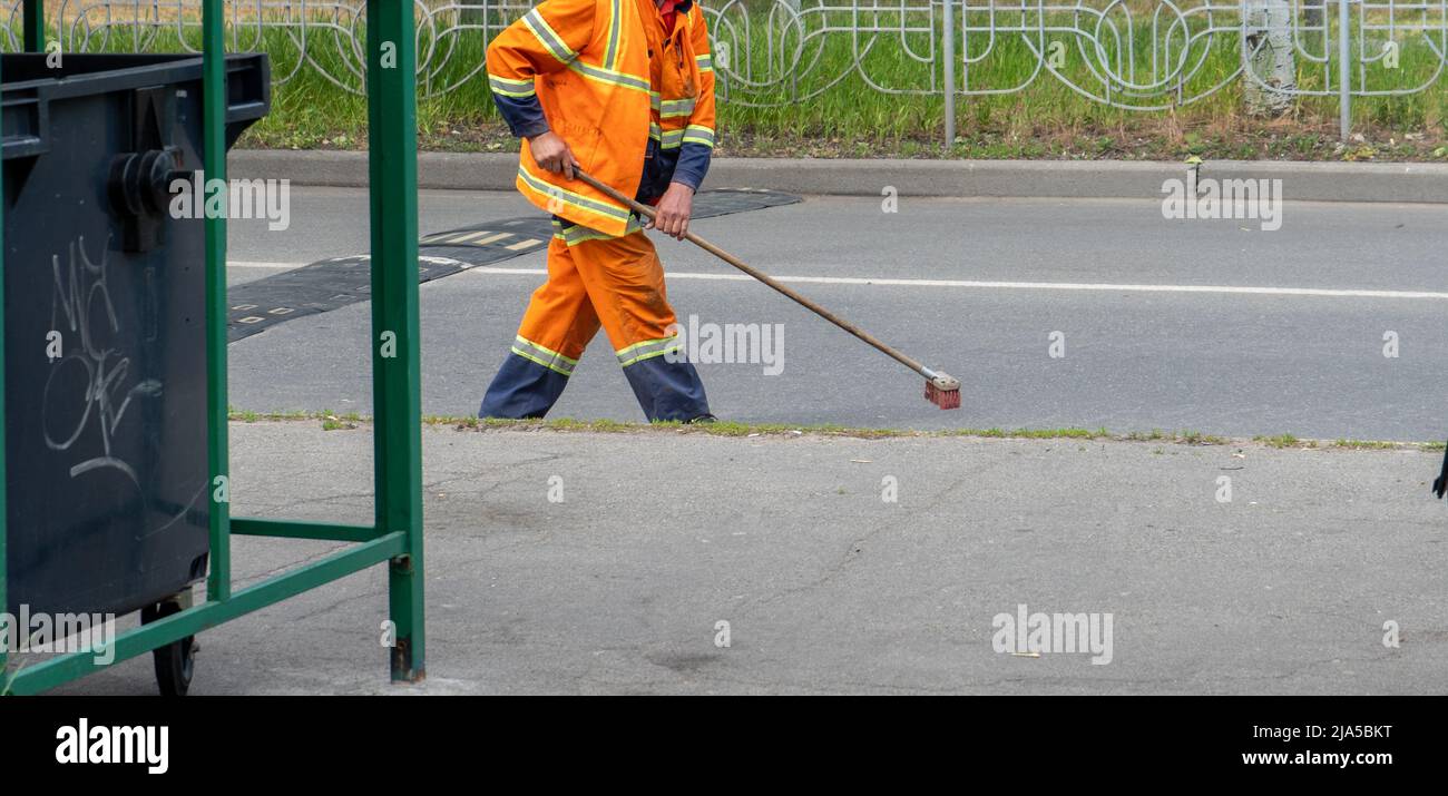 Man cleaner sweeping street with broom, municipal worker in uniform ...