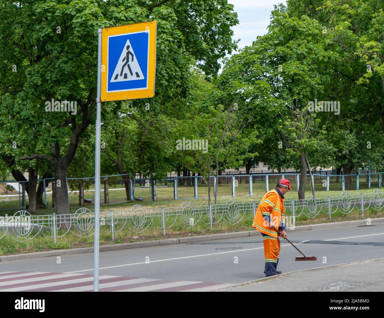 Cleaner sweeping uniform urban hi-res stock photography and images - Alamy