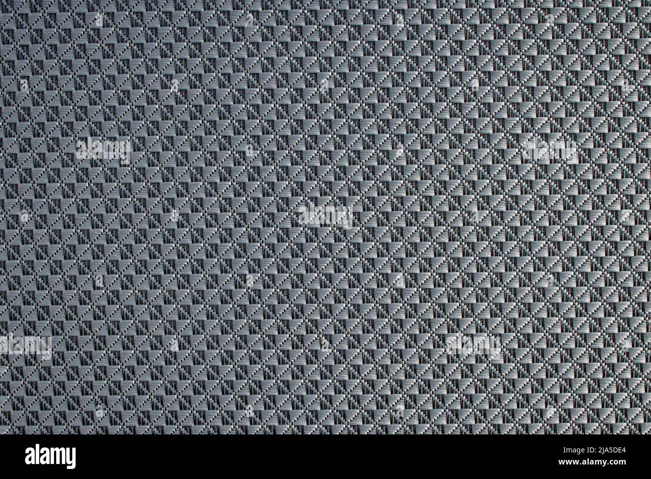 Close up of gray synthetic textured fabric with a rhombus pattern used ...