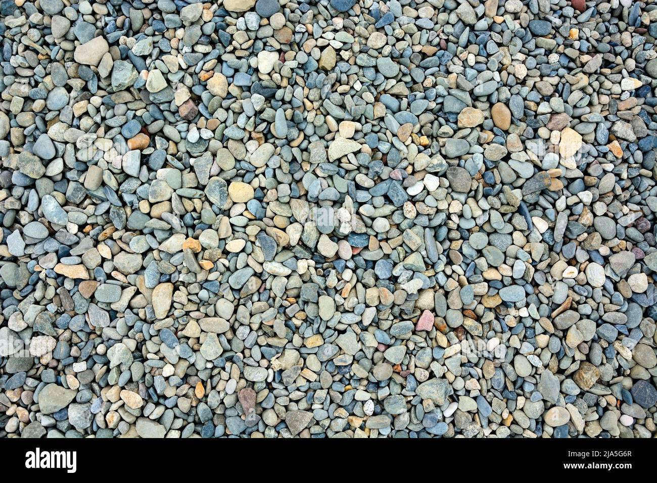 Pebbles at the sea shore- background Stock Photo - Alamy