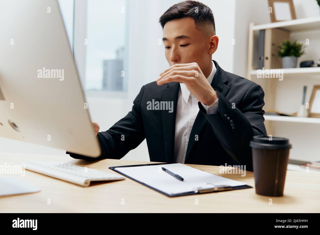 man works at the computer glass of coffee emotion office technologies Stock Photo - Alamy