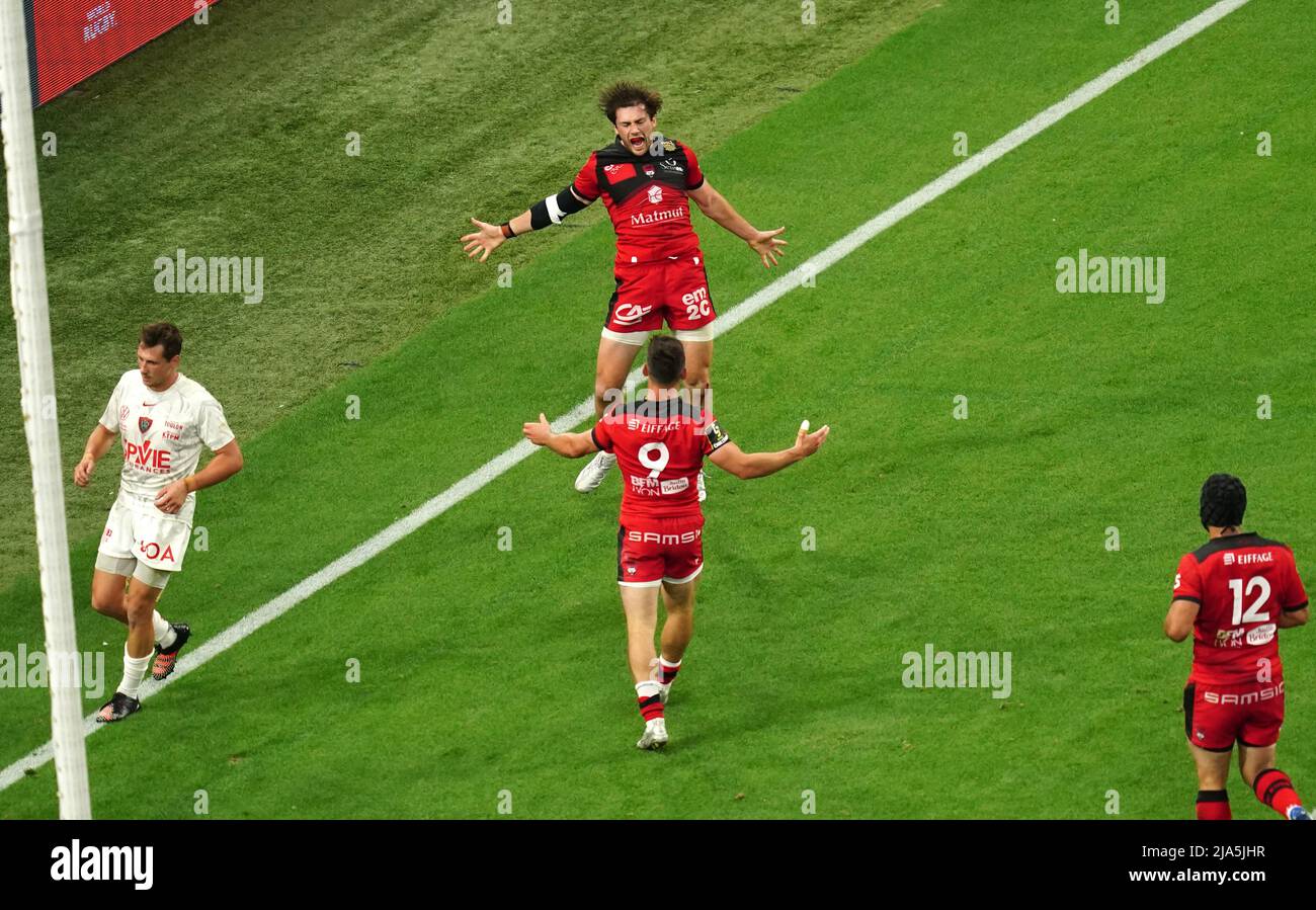 Lyon's Pierre Louis Barassi (top) celebrates scoring their side's ...