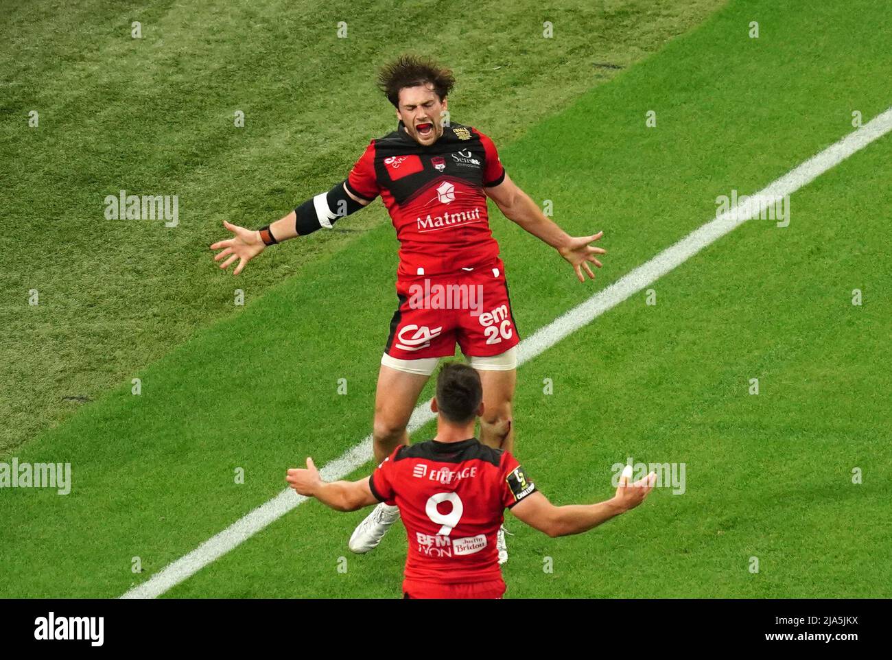 Lyon's Pierre Louis Barassi (top) celebrates scoring their side's ...
