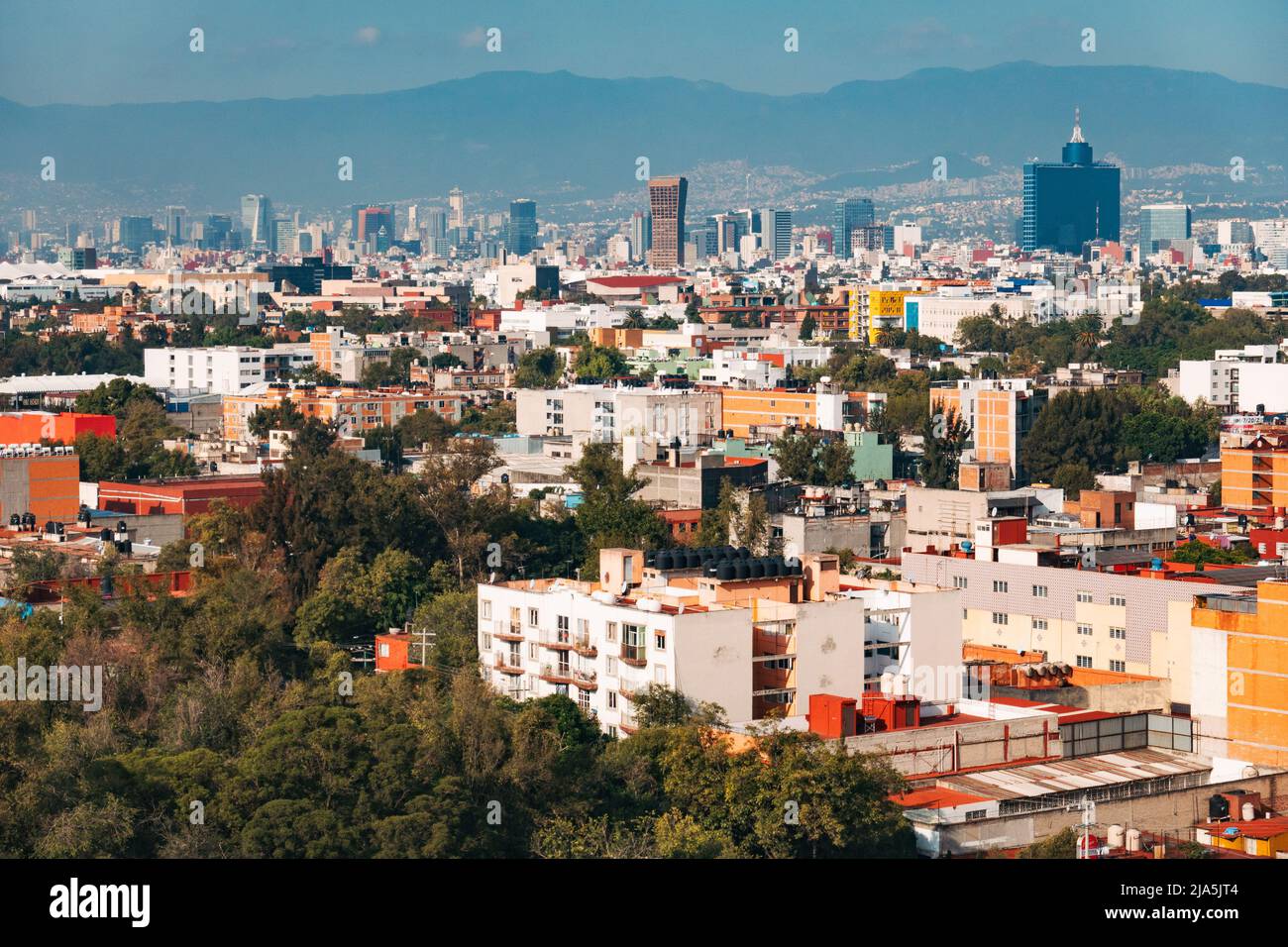 a vibrant Mexico City skyline as seen from atop an apartment building ...