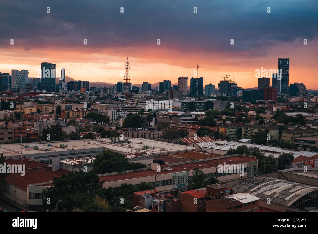 A dramatic and fiery sunset over the skyline of Mexico City, Mexico ...