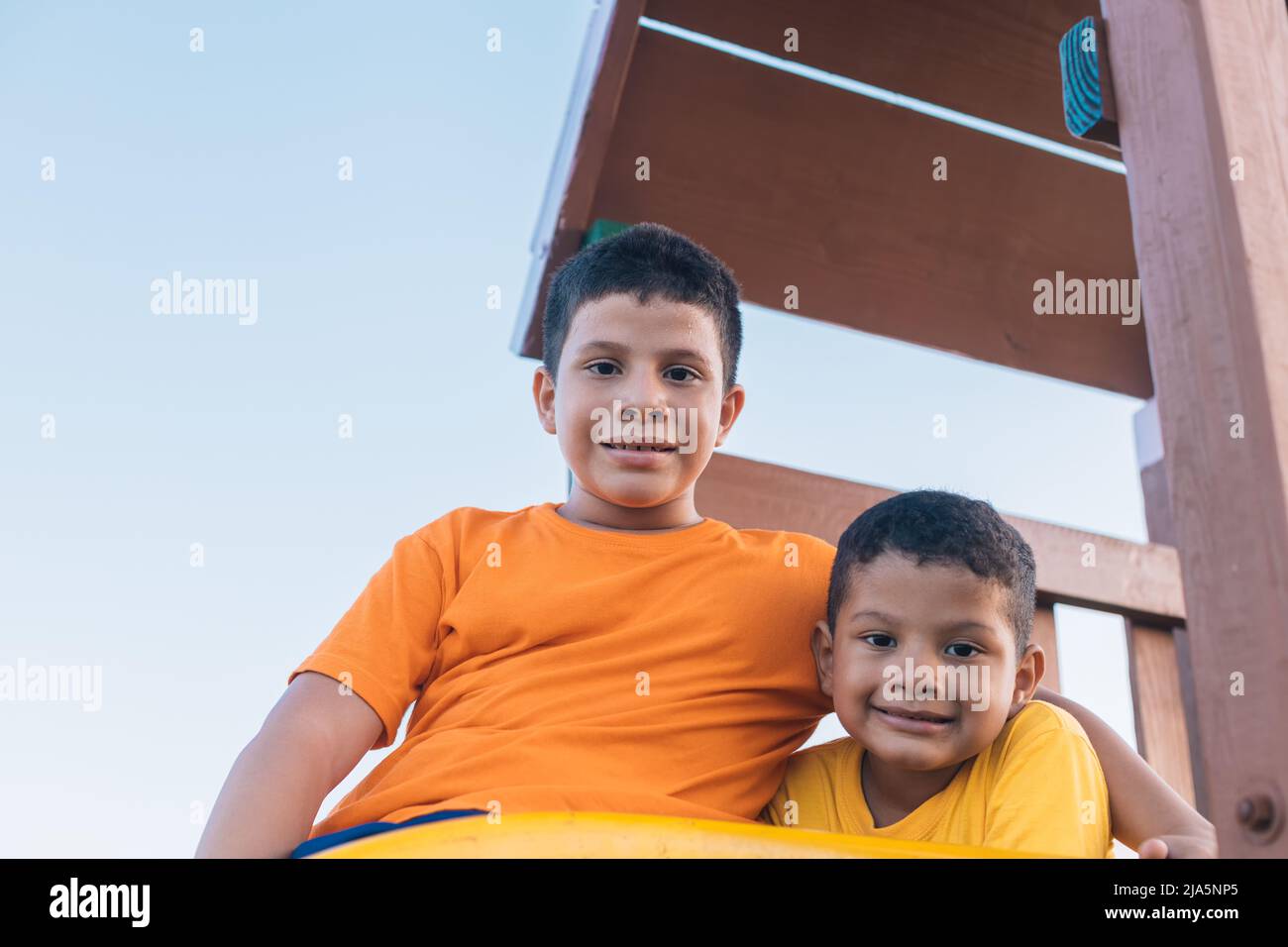 children smiling, sitting looking at the camera Stock Photo - Alamy