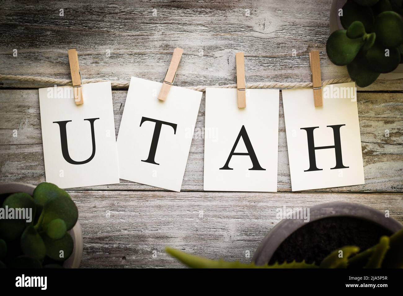 A set of printed cards spelling the word UTAH on an aged wooden ...