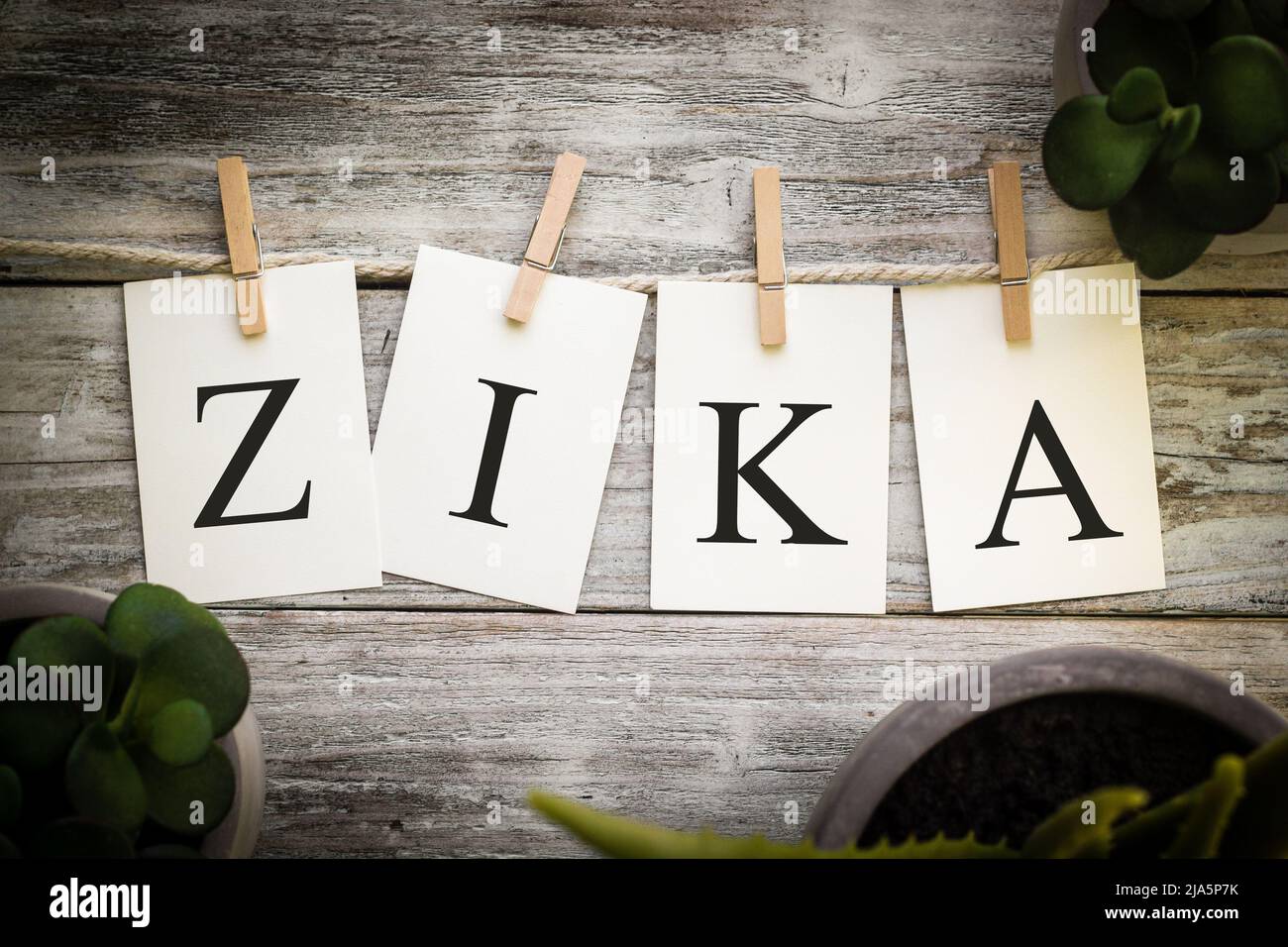 A set of printed cards spelling the word ZIKA on an aged wooden ...