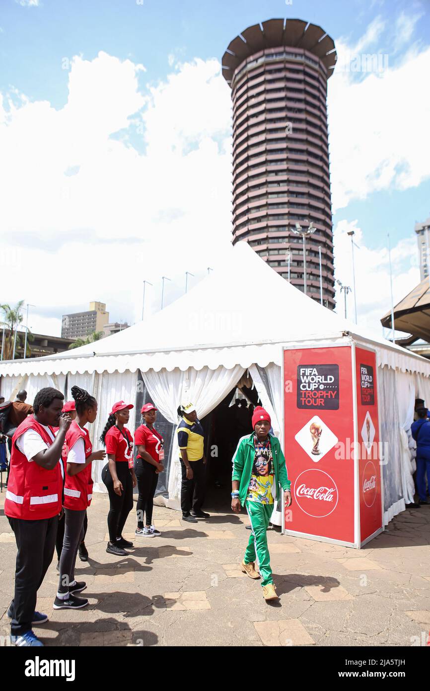 A Kenyan soccer fan walks out after viewing the trophy during the FIFA ...