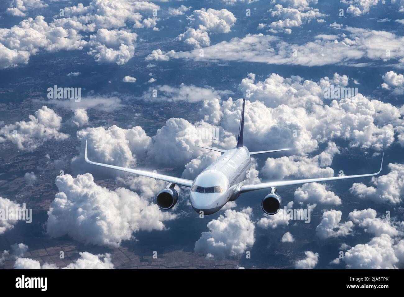 Airplane is flying above the clouds at sunset in summer Stock Photo - Alamy