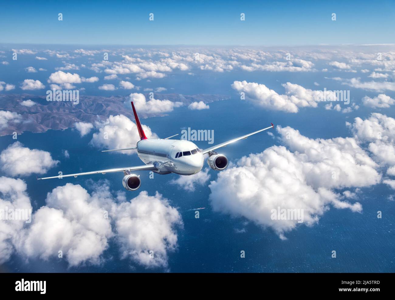Airplane is flying above the clouds at sunset in summer Stock Photo - Alamy