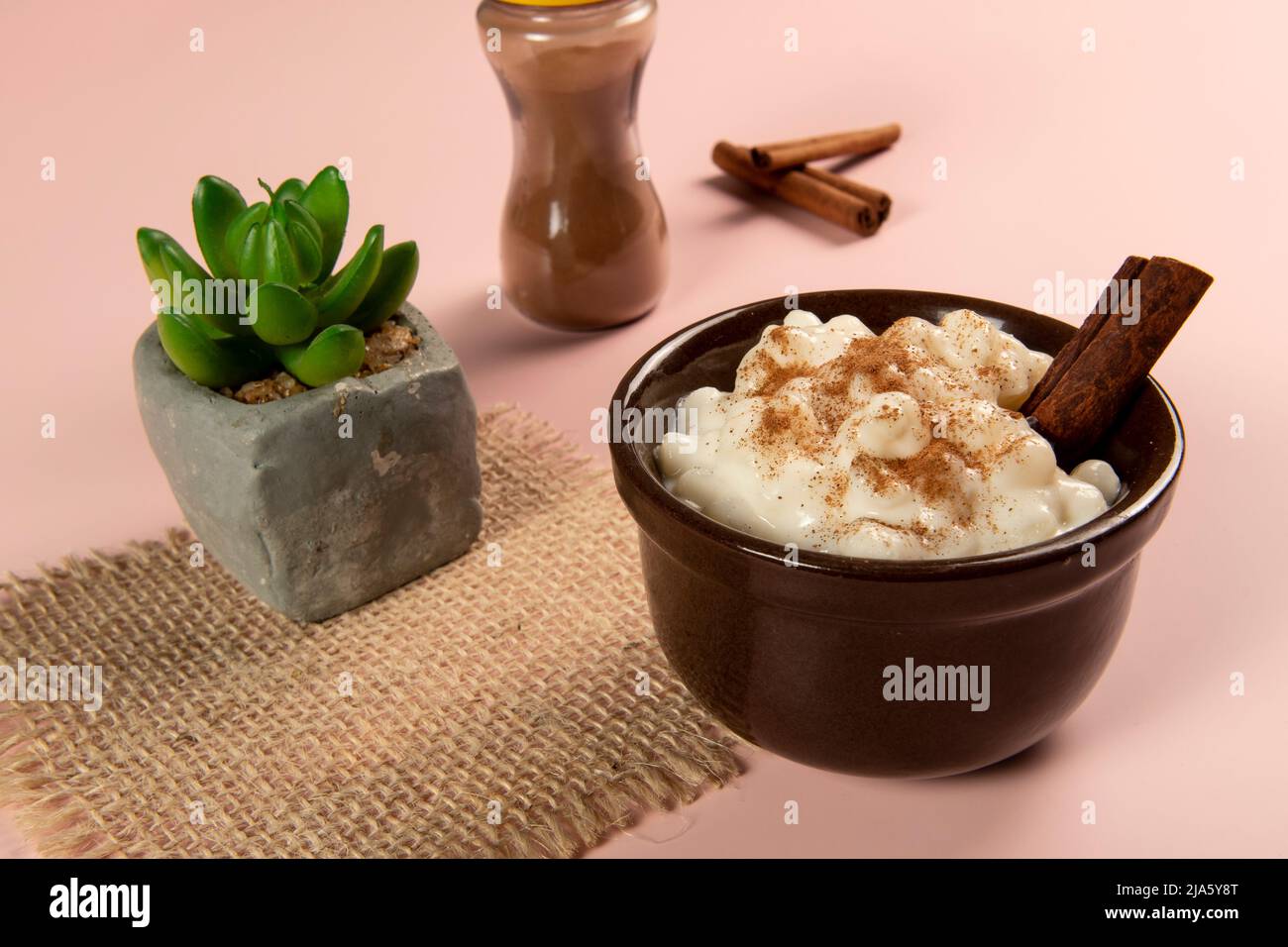 Brazilian sweet dessert, Canjica. White corn porridge with cinnamon and ...