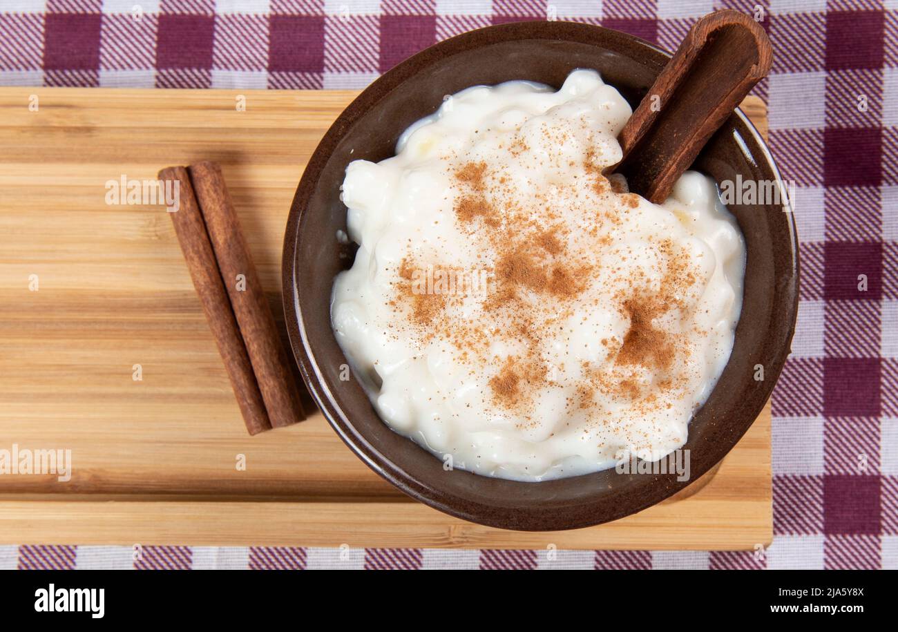 Brazilian sweet dessert, Canjica. White corn porridge with cinnamon and ...