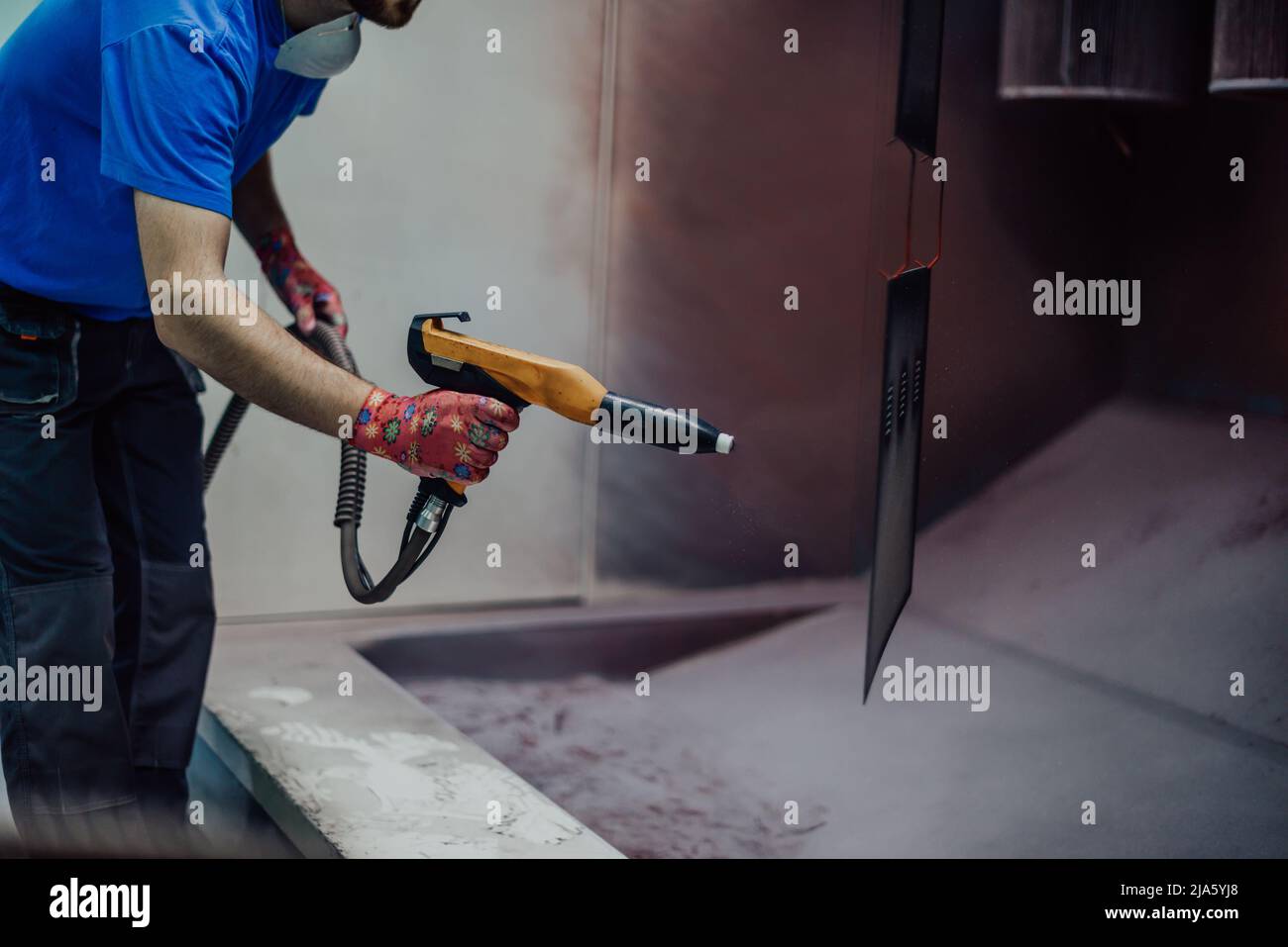 The painter paints the iron element. Industrial painting parts. Metal ...