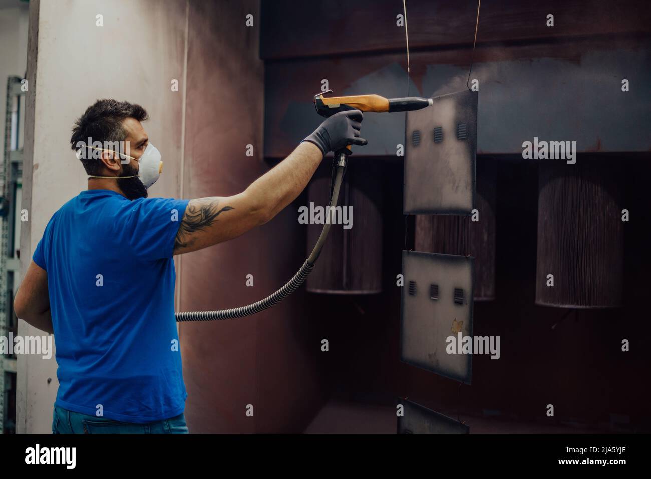 The painter paints the iron element. Industrial painting parts. Metal ...