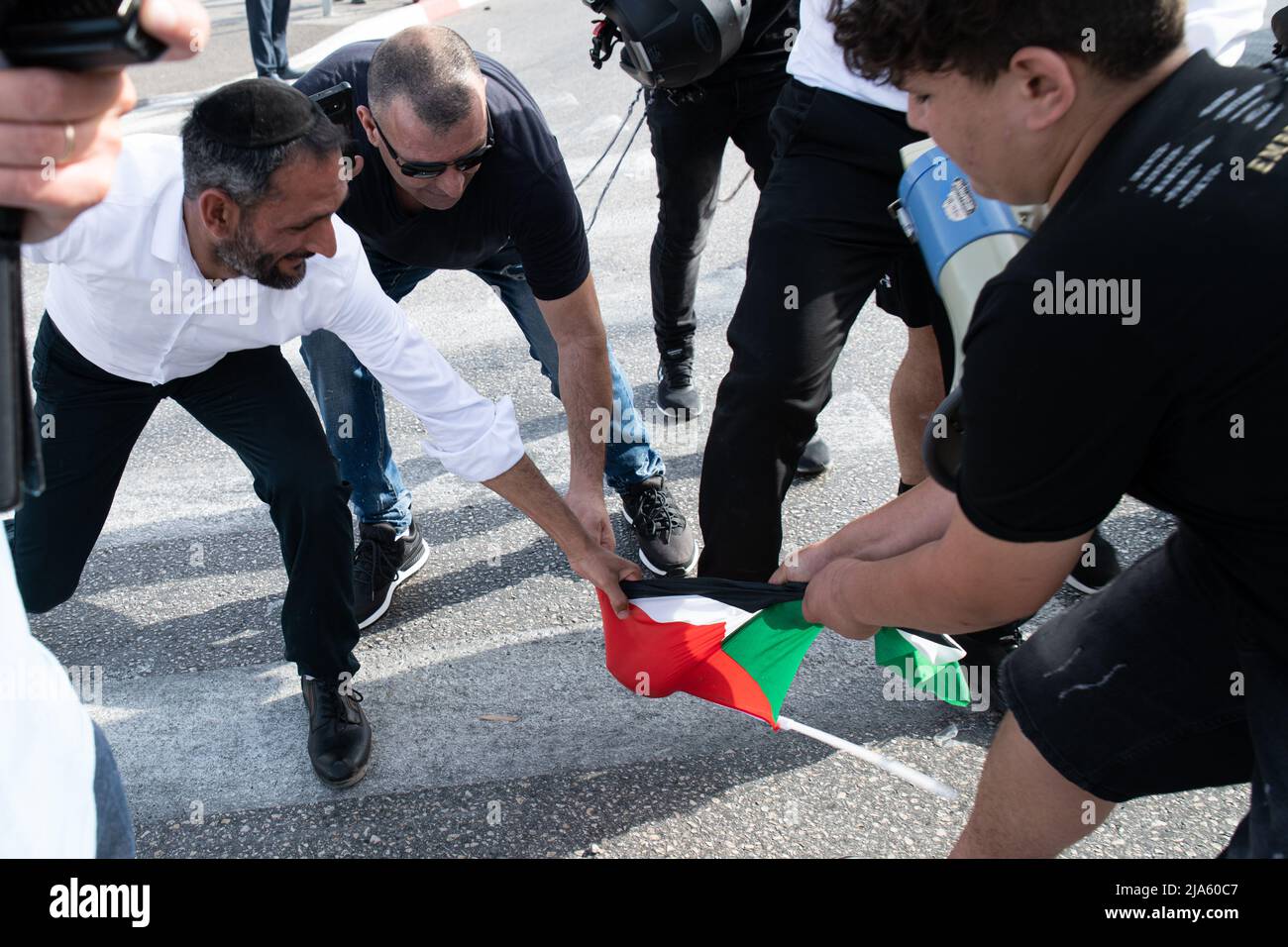 Right wing protestors try to steal a flag from a Palestinian protestor ...