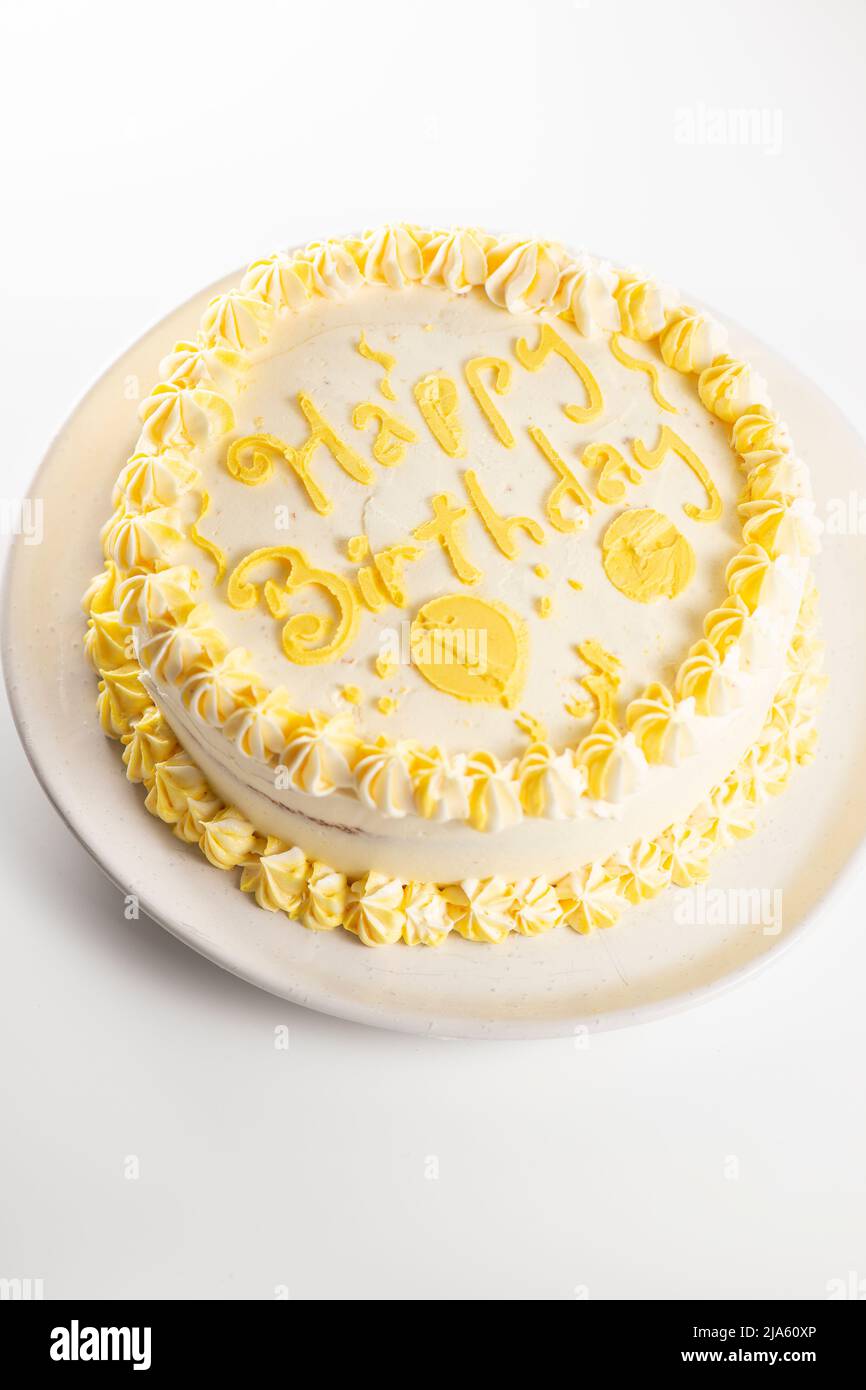Lemon flavoured Happy Birthday Sponge cake with yellow decorative icing ...