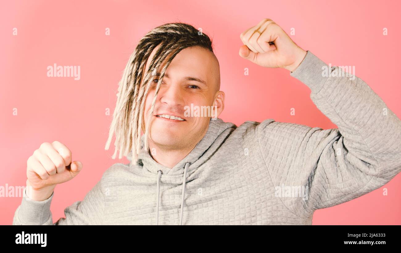 Young man with dreadlocks they dance expressively gesticulating with ...