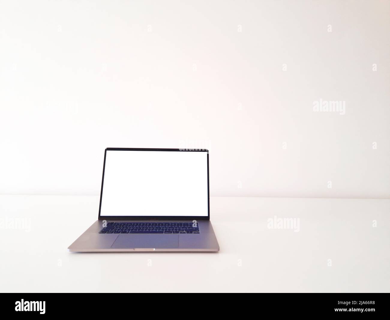 laptop on white table front view Stock Photo - Alamy