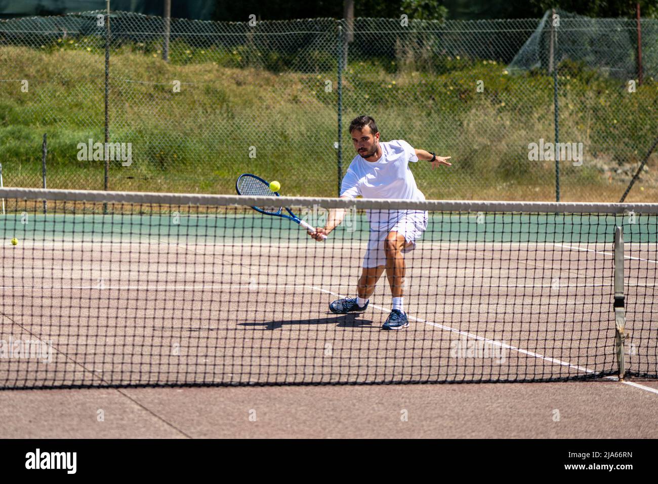 Tennis player performing a drop shot on court Stock Photo - Alamy