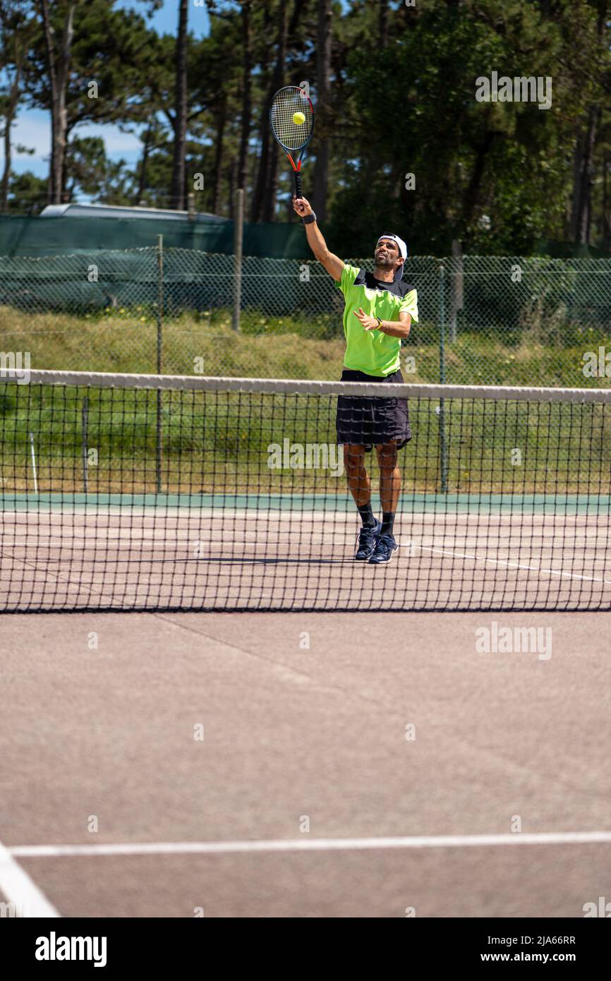 Tennis player performing a smash on court Stock Photo - Alamy