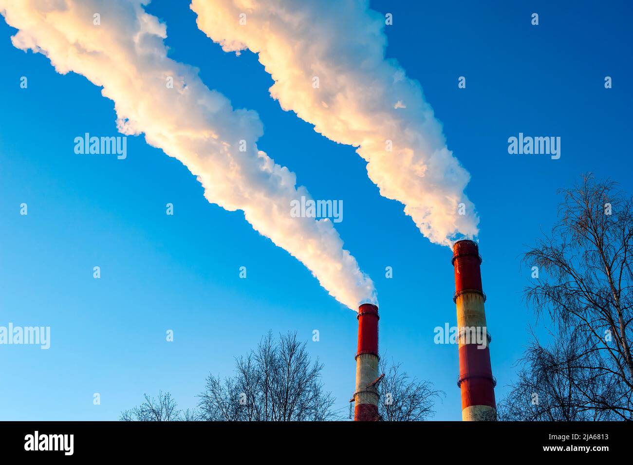 white smoke is coming out of the pipes in the blue sky Stock Photo - Alamy
