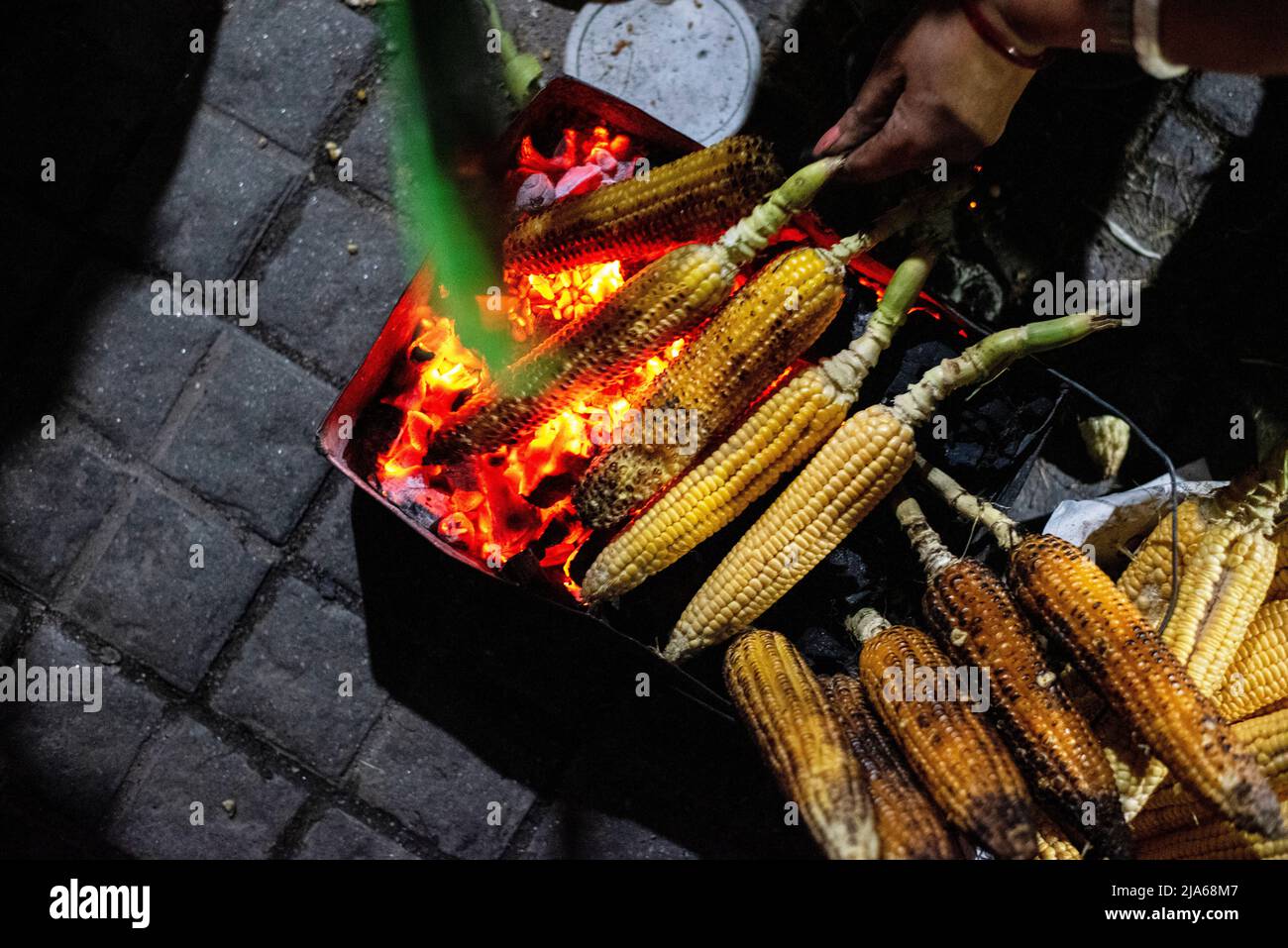 Traditional roasted corn cob in country made oven. Grilled corn ...