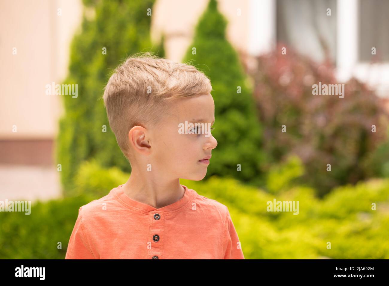 five-year-old boy making faces. A five-year-old blond boy makes faces ...