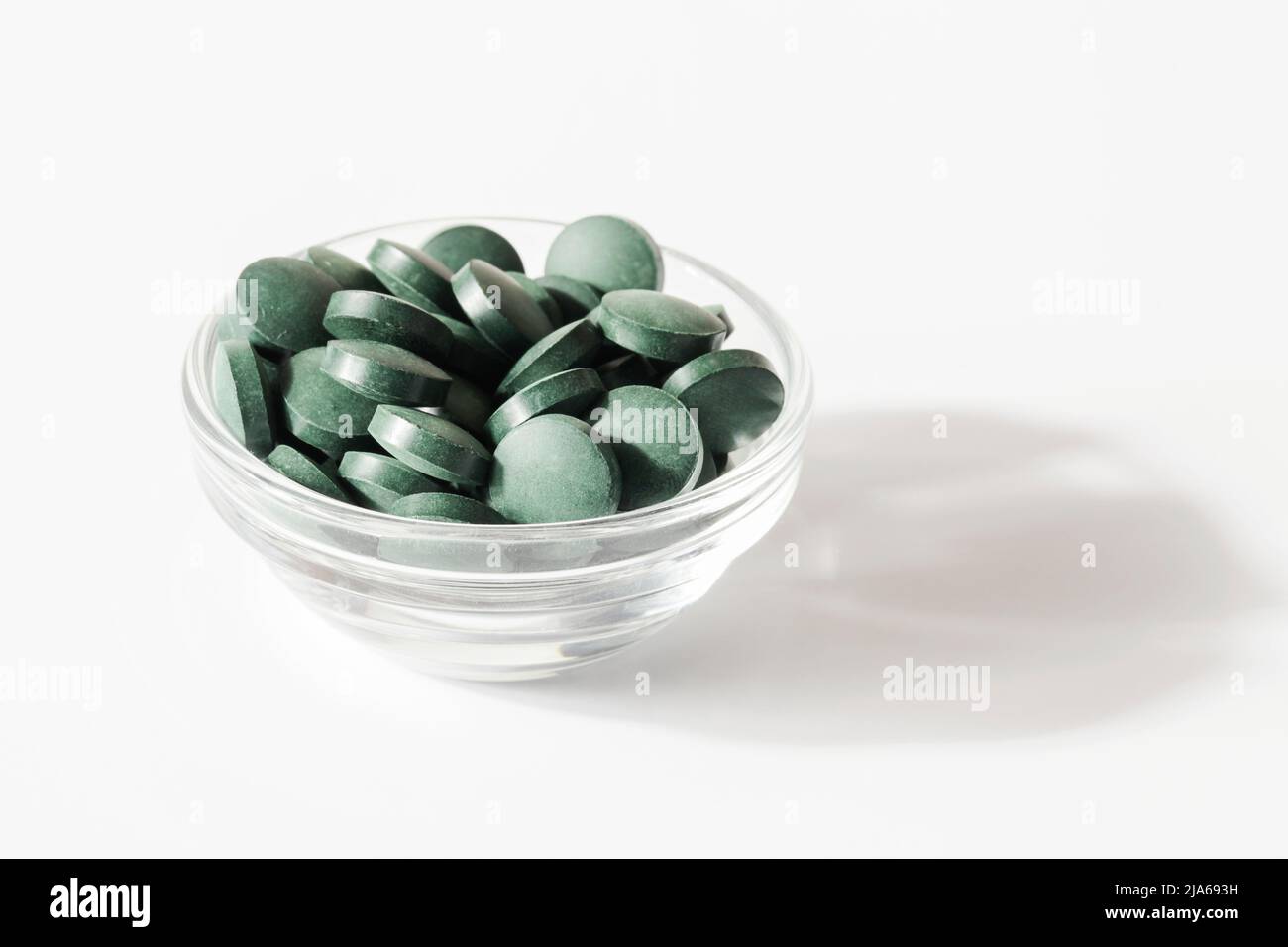 natural additives and superfood.green spirulina algae pills in glass ...