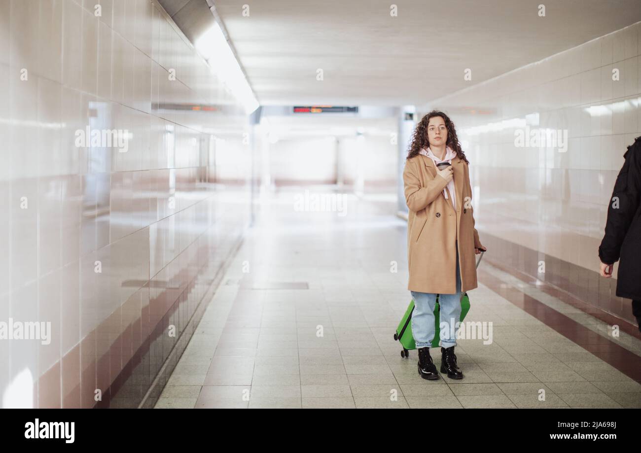 Woman traveler tourist going trough station with luggage Stock Photo ...