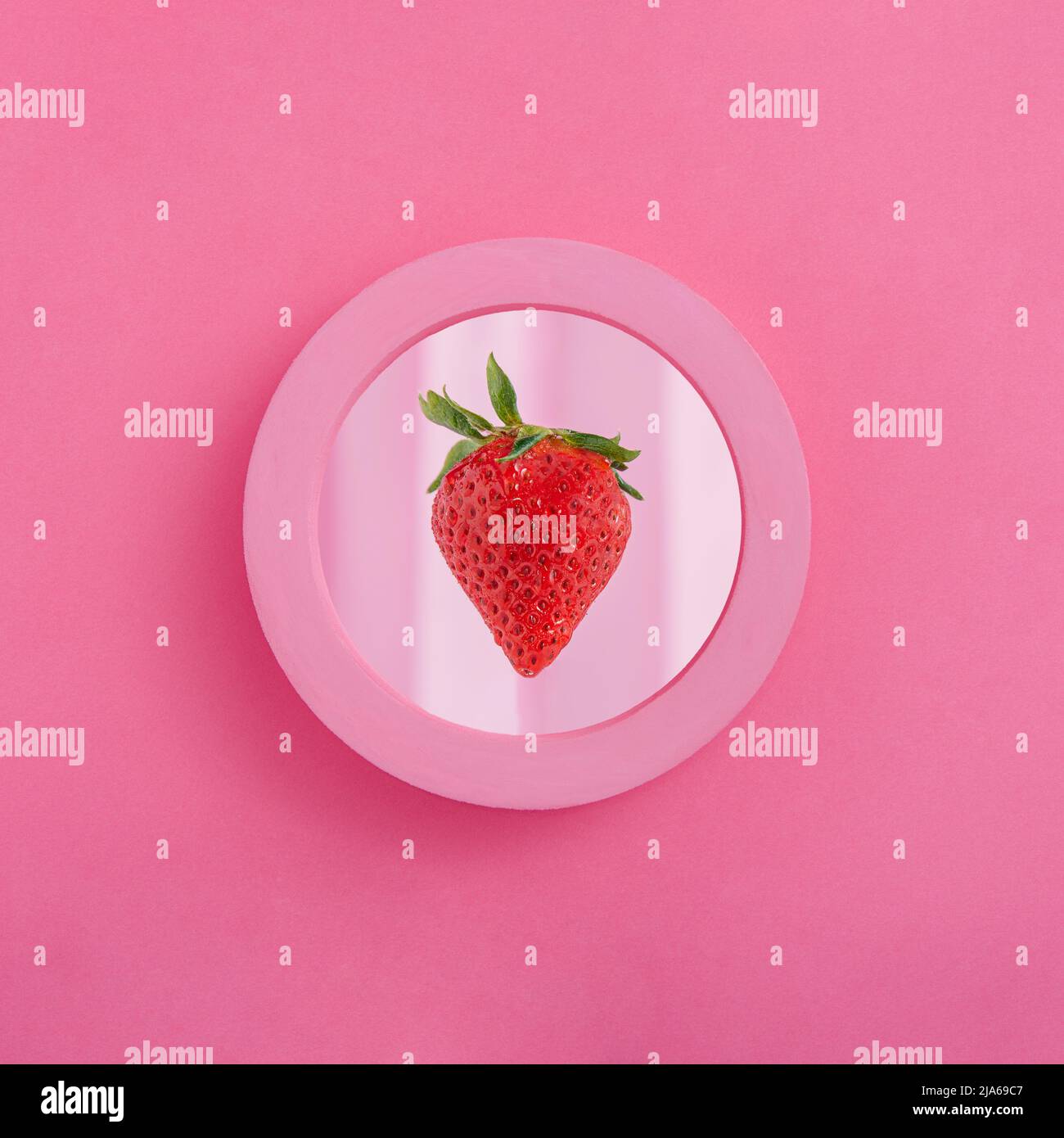 Strawberry in a pink round frame. Summer monochrome layout. Minimal ...