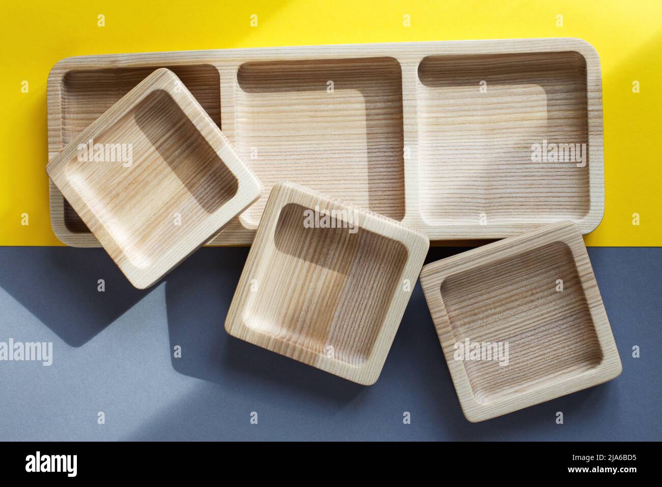 wood empty plates for snack on the color grey and yellow background ...